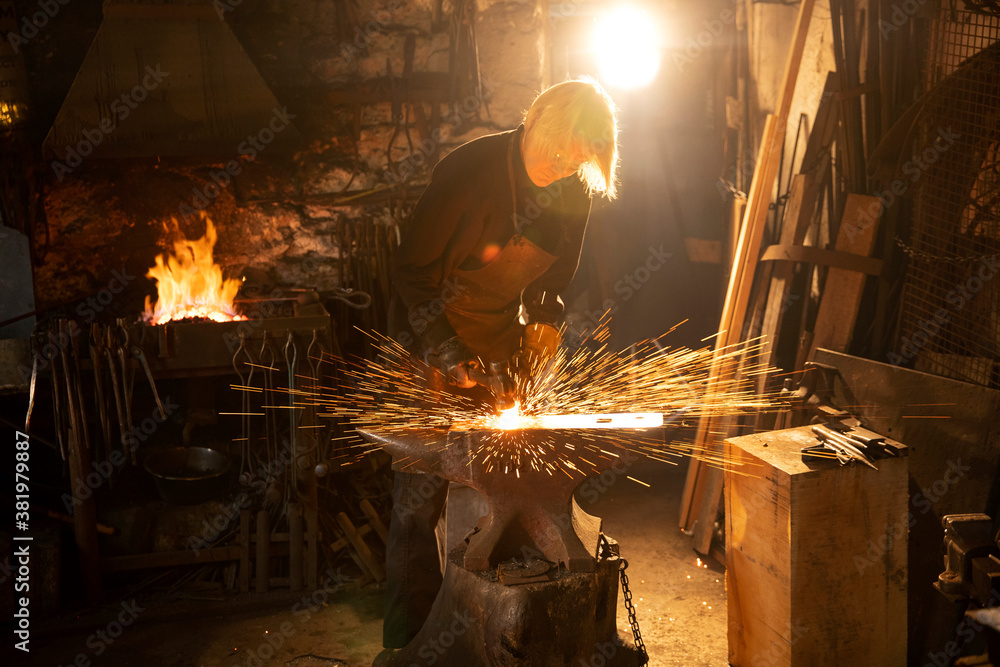 Female blacksmith working in workshop Stock Photo | Adobe Stock