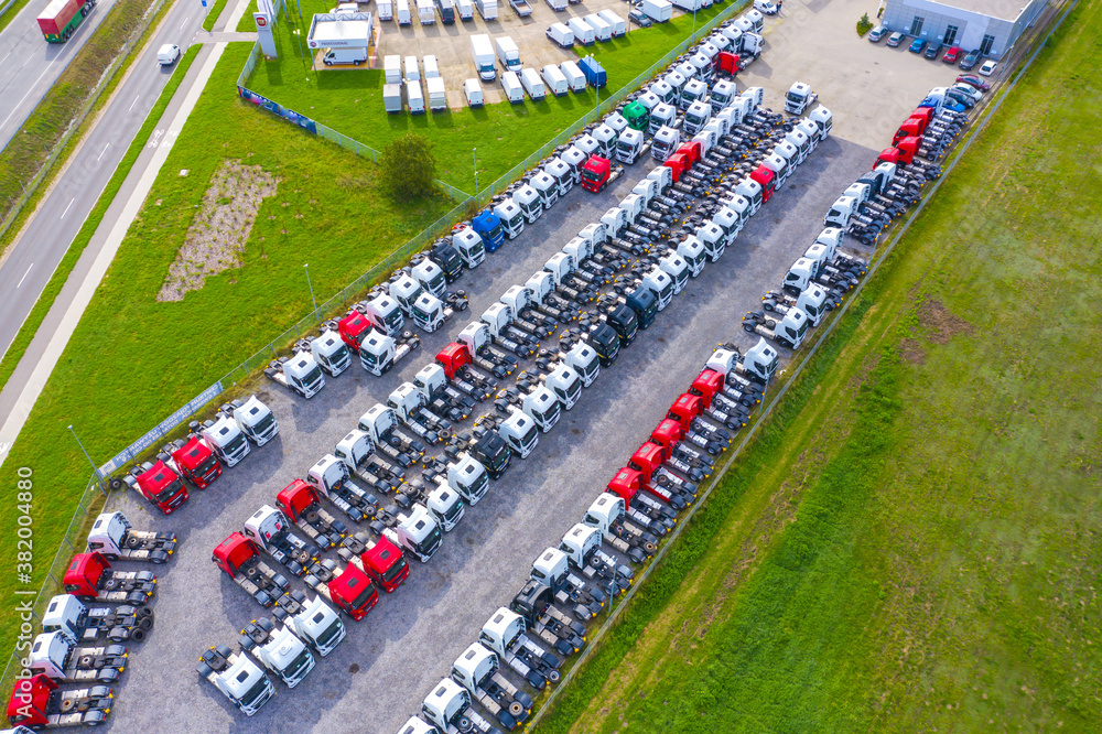 Aerial view of a car distribution centre, new cars parked in rows on a ...