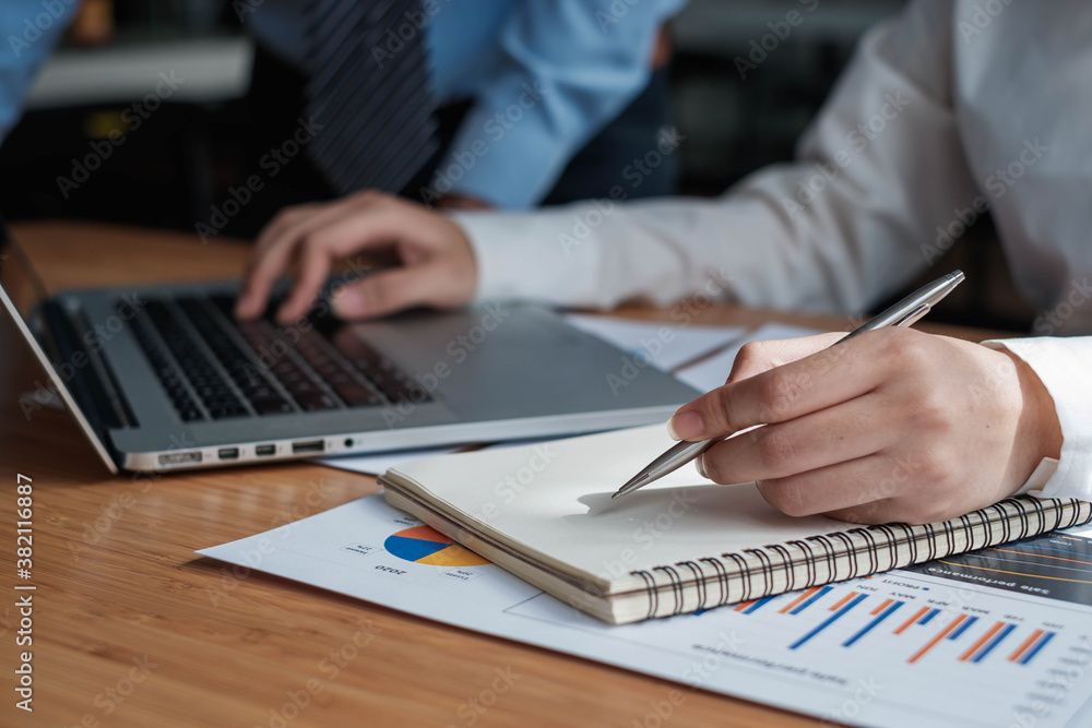 Businessman are taking notes at work to summarize business proposals ...