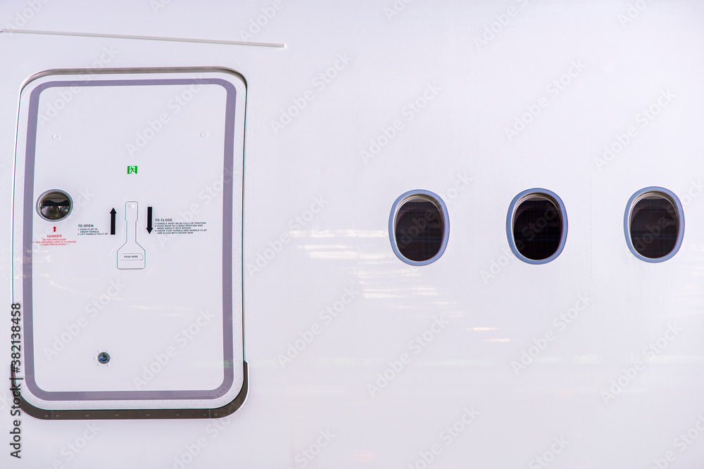 Emergency exit on the fuselage of a passenger aircraft and Passenger ...