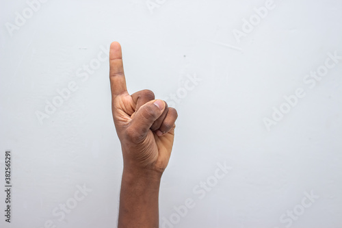 Boy hand showing number one gesture symbol isolated on white background ...