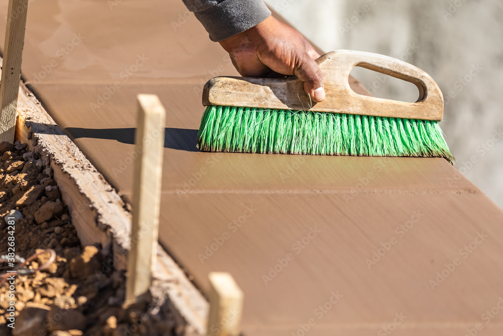 Construction Worker Using Brush On Wet Cement Forming Coping Around New ...