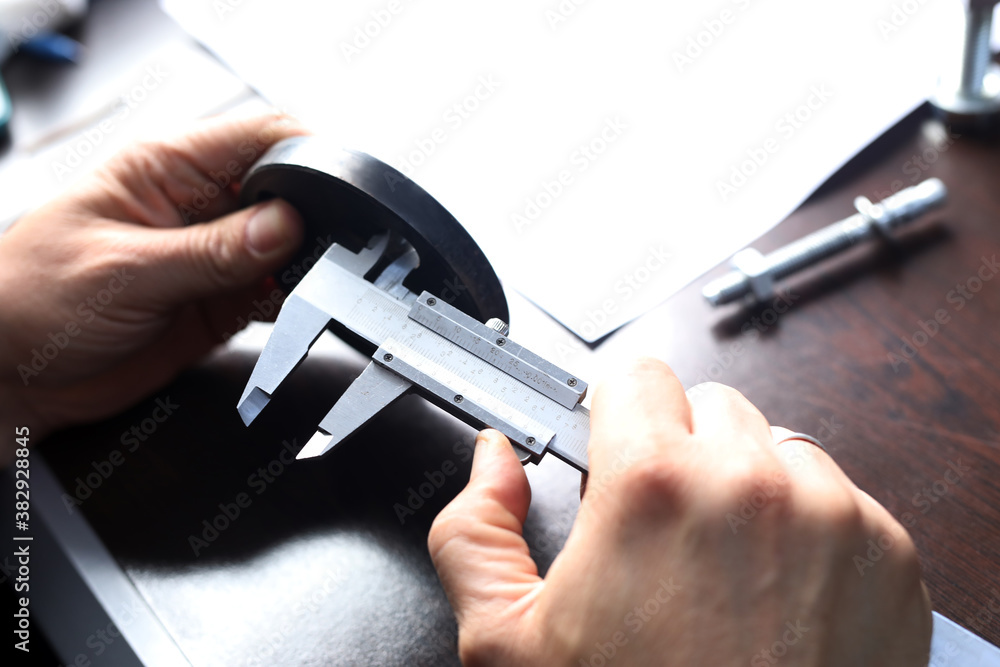 The worker is measuring to holes of inner diameter of flange with ...