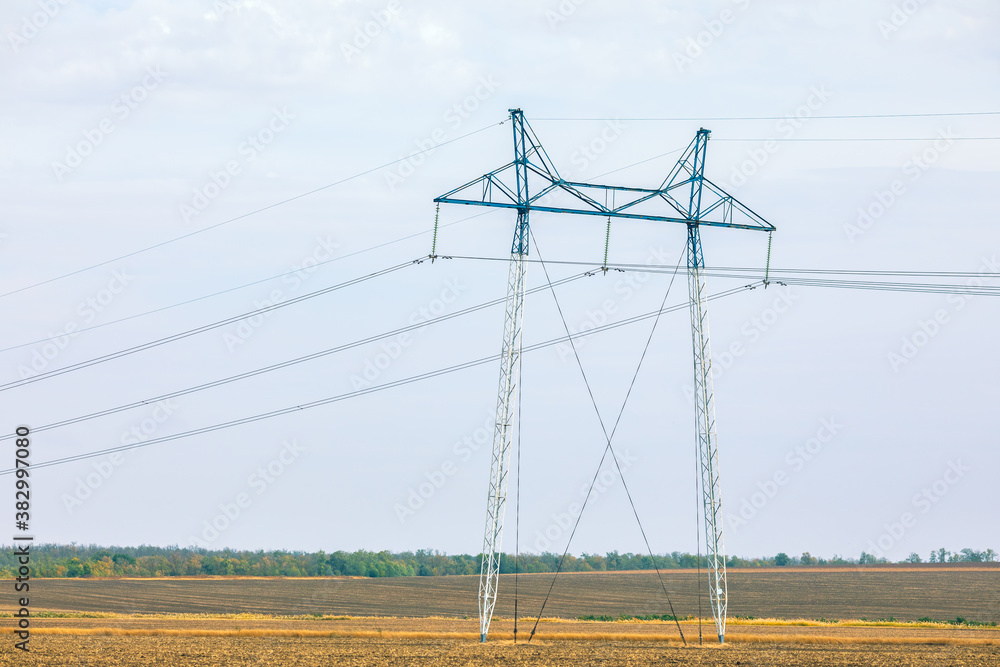Power lines and high voltage lines in the background of the field ...