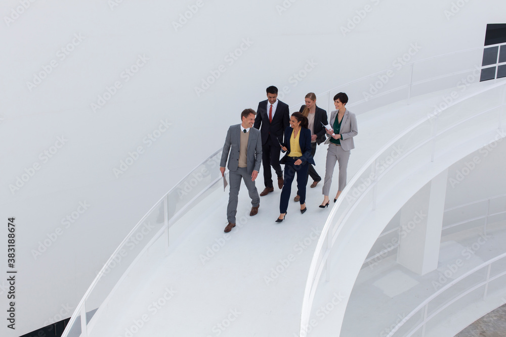 Corporate business people walking on modern ramp Stock Photo | Adobe Stock