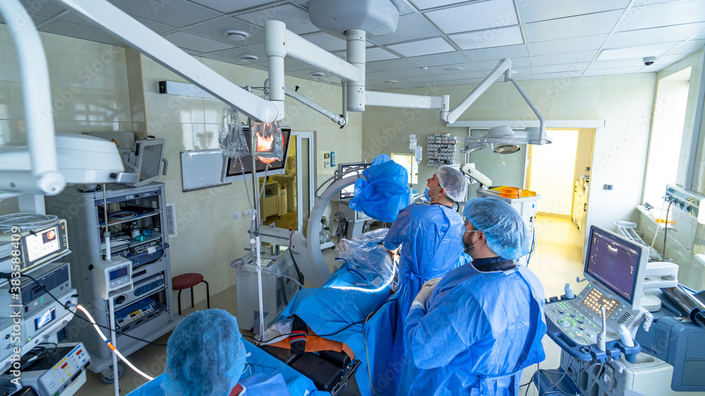 Spinal surgery. Group of surgeons in operating room with surgery ...