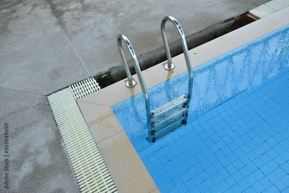 Swimming pool. Grab bars ladder made from stainless steel and beautiful ...