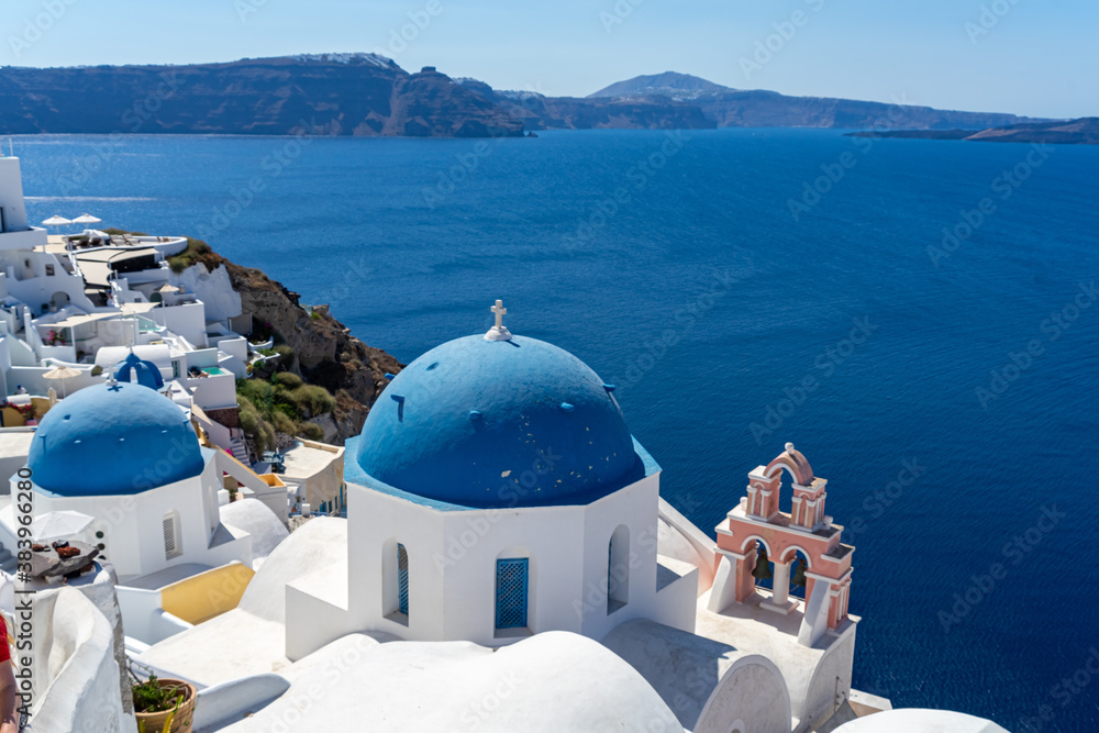 Iconic view of Santorini, with typical blue dome church, sea and white ...