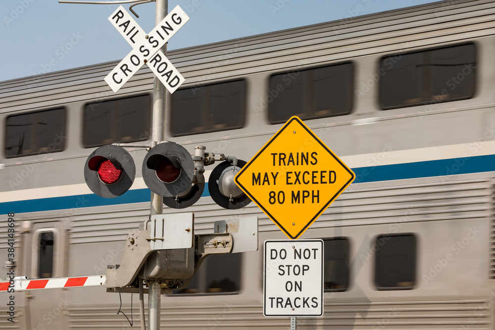 High speed train warning sign at railroad crossing with motion blur of ...