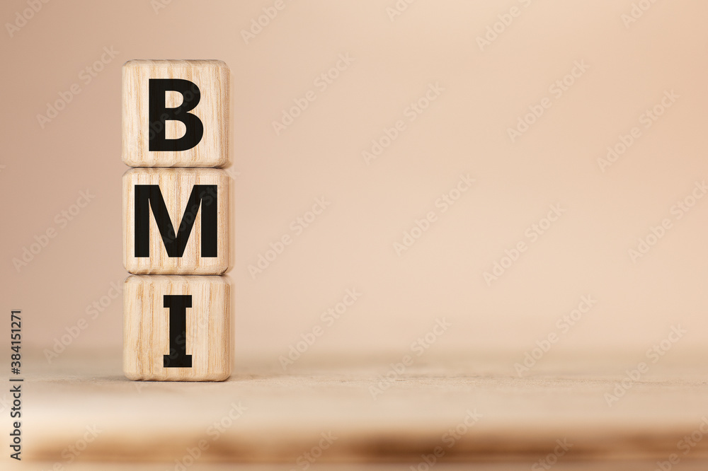 Word BMI body mass indexon on wooden blocks beige background top view ...