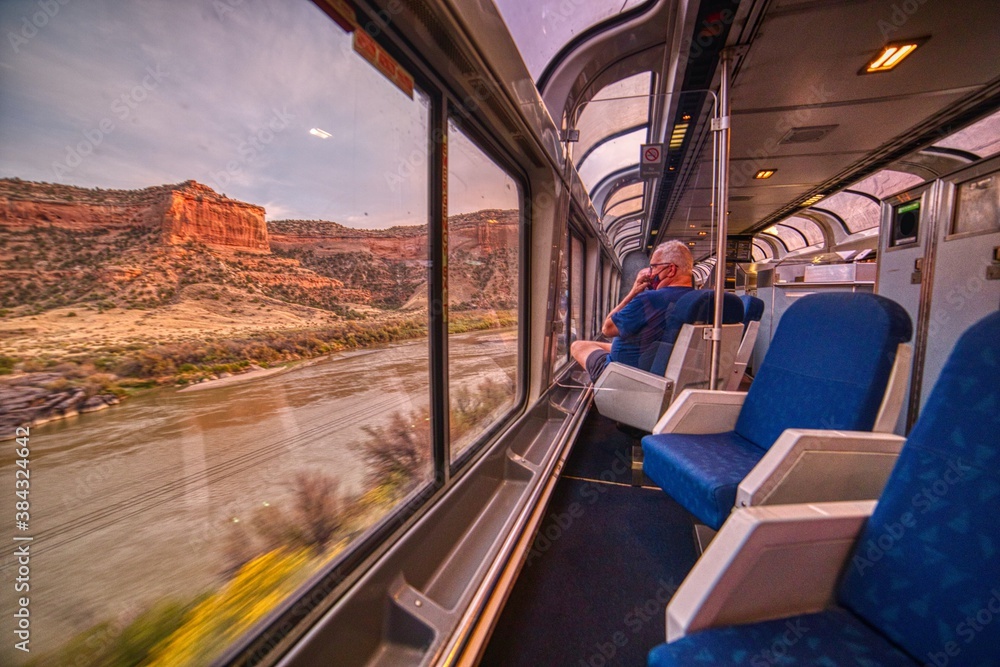 Amtrak Train crossing through the Colorado Rocky Mountains with peak ...