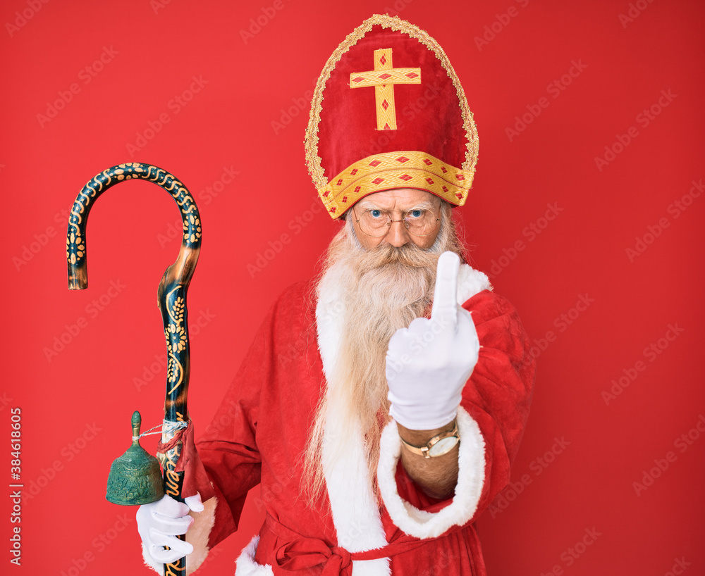 Old senior man with grey hair and long beard wearing traditional saint ...