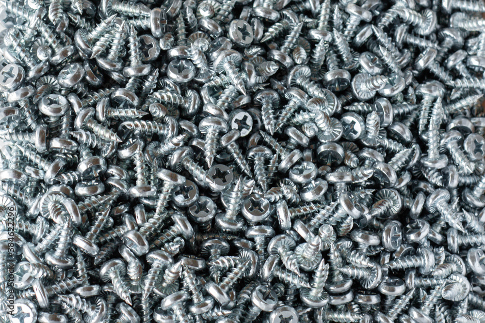 tapping screw for dry wall, gray background, small construction tolls ...