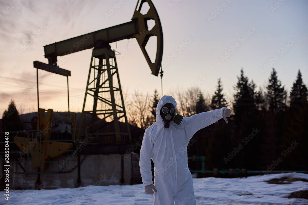 Scientist in gas mask, protective suit showing disapproval gesture ...