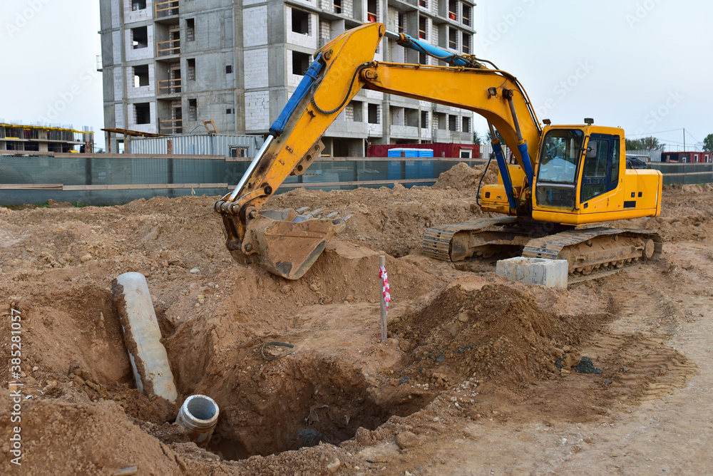 Excavator dig the trenches at a construction site. Trench for laying ...