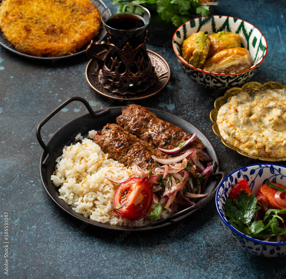 Traditional Turkish dish meat kebab with rice, vegetables served with ...