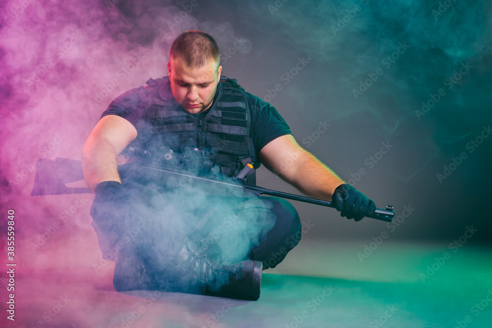Soldier comes out of the smoke on the battlefield. The concept of ...
