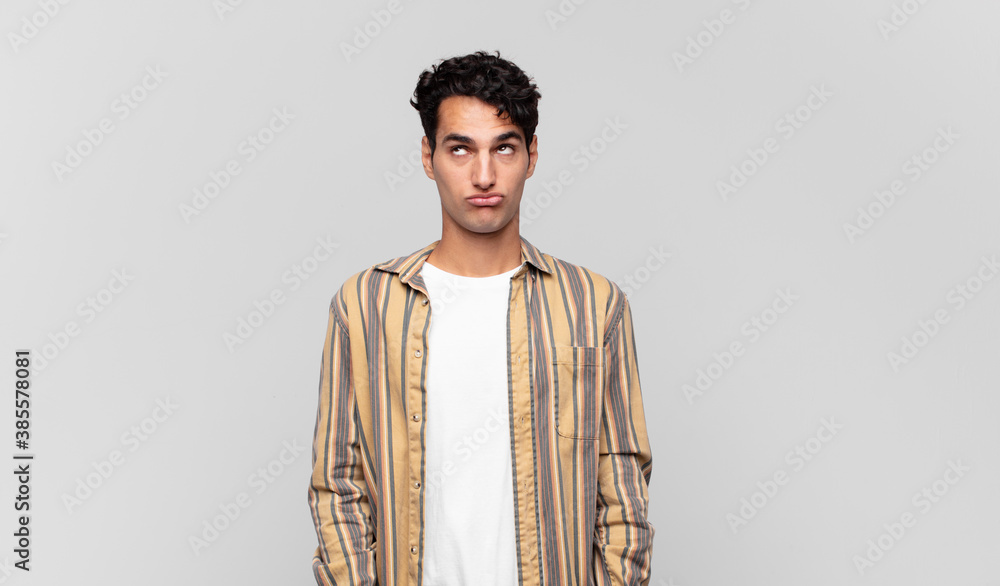 young handsome man looking goofy and funny with a silly cross-eyed ...