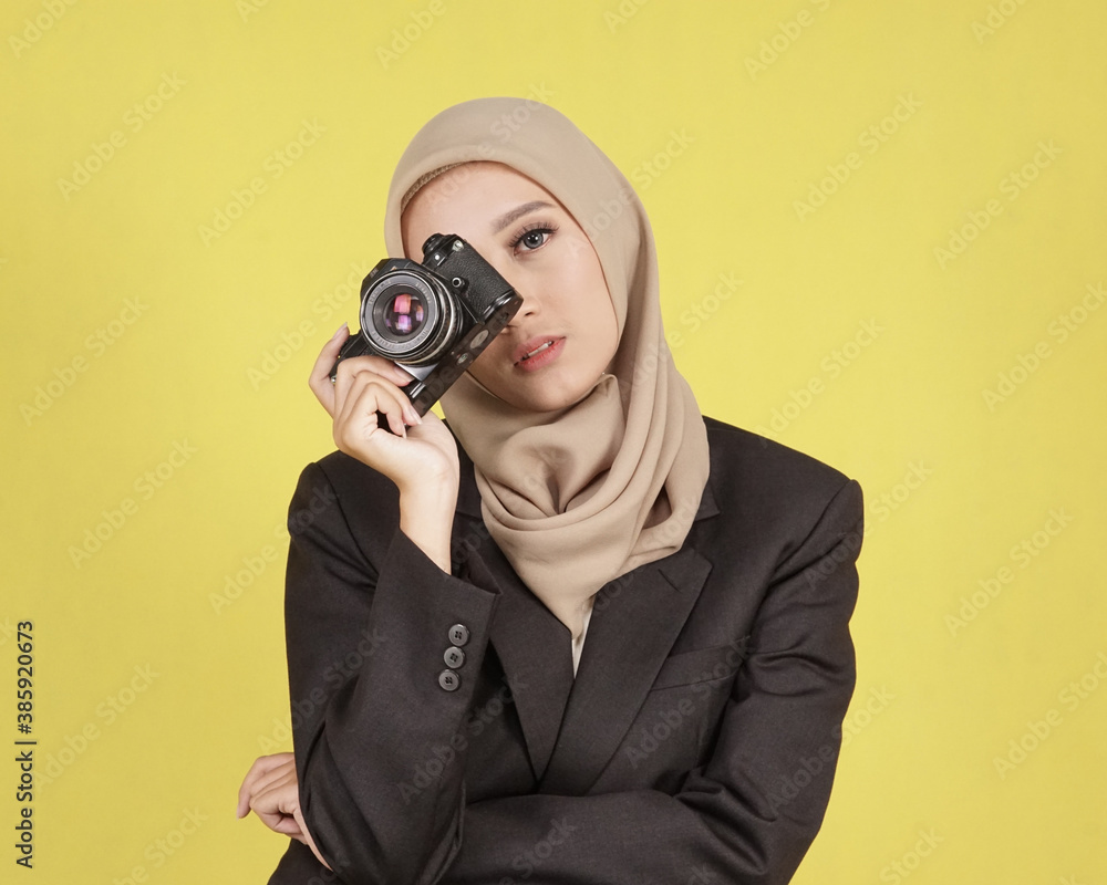 Hijab female models pose like famous models. The woman is wearing a set ...