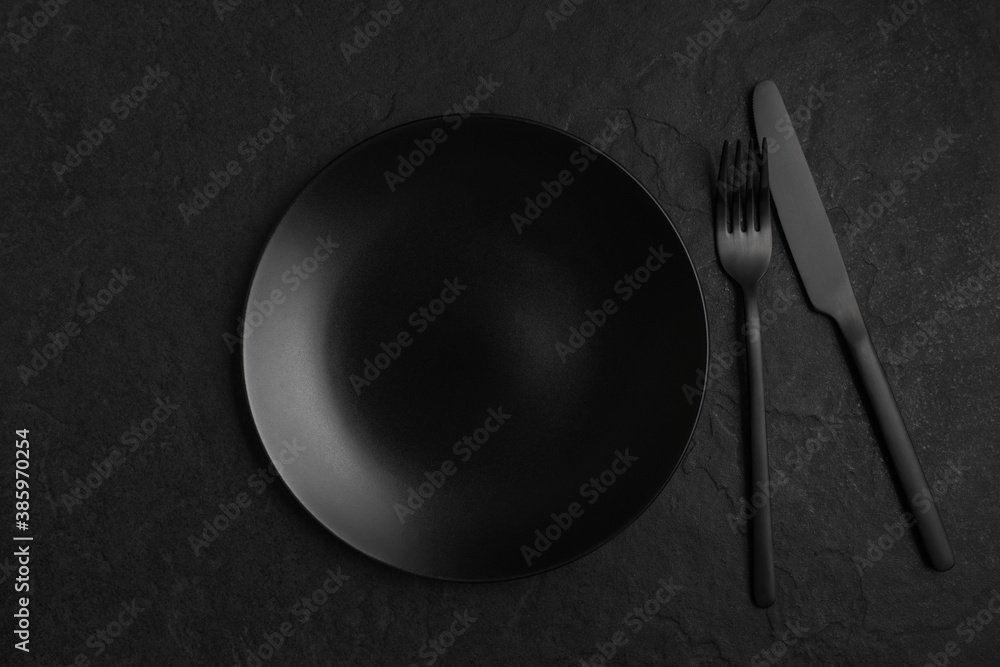 Black background with plate and cutlery, monochrome table setting Stock ...
