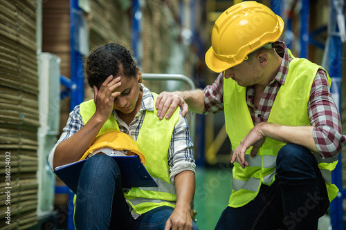 Young African female warehouse worker staff feeling sad and stress ...
