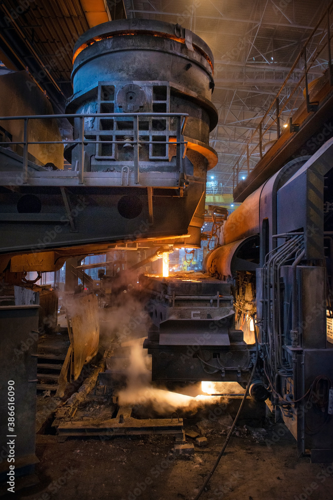 Steel production in electric furnaces. Sparks of molten steel. Electric ...