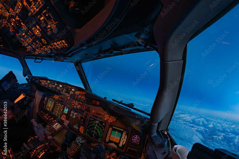 Flight Deck of modern passenger airplane, pilots view in cruise during ...