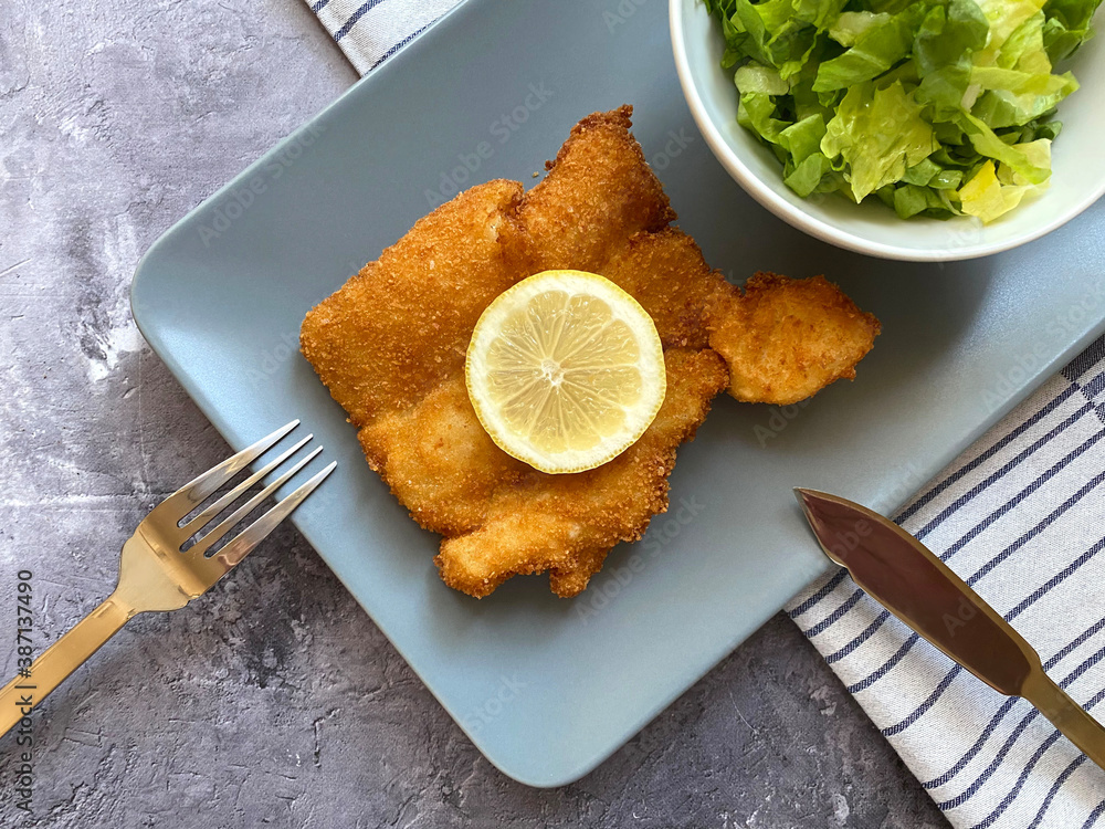 Breaded cod fish fillet, also known as Kabeljau. The fish is coated in ...