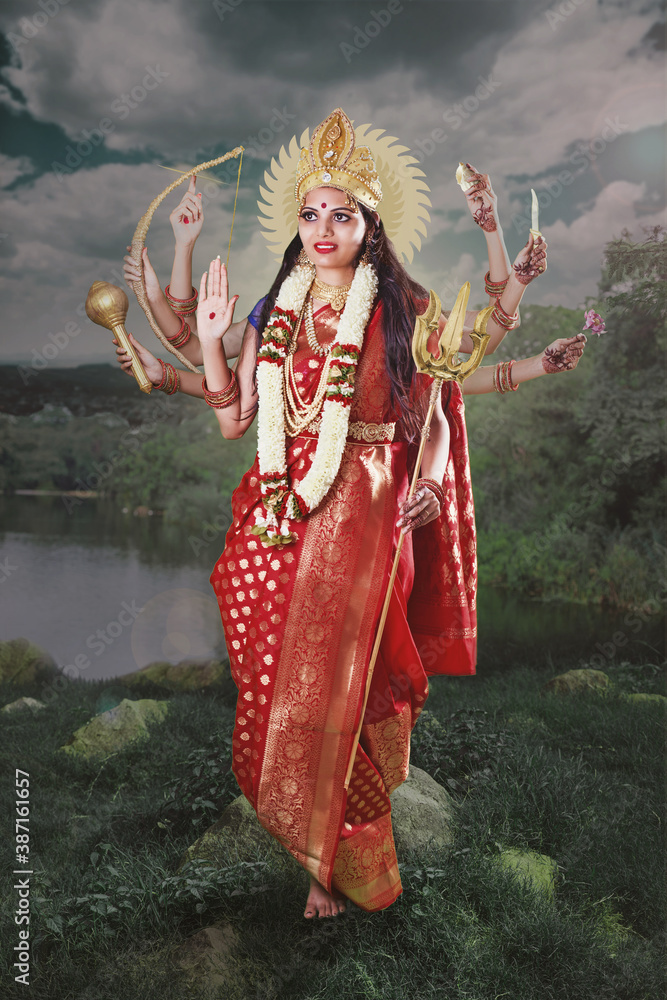 Indian Goddess Durga with eight hands standing near the lake Stock ...