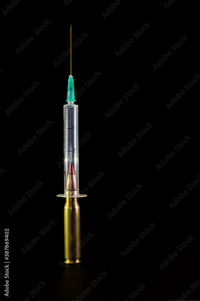 Bullet inside a syringe on black background.Concept of illness or viral ...