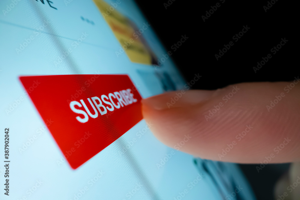 Clicking the subscribe button in YouTube Stock Photo | Adobe Stock
