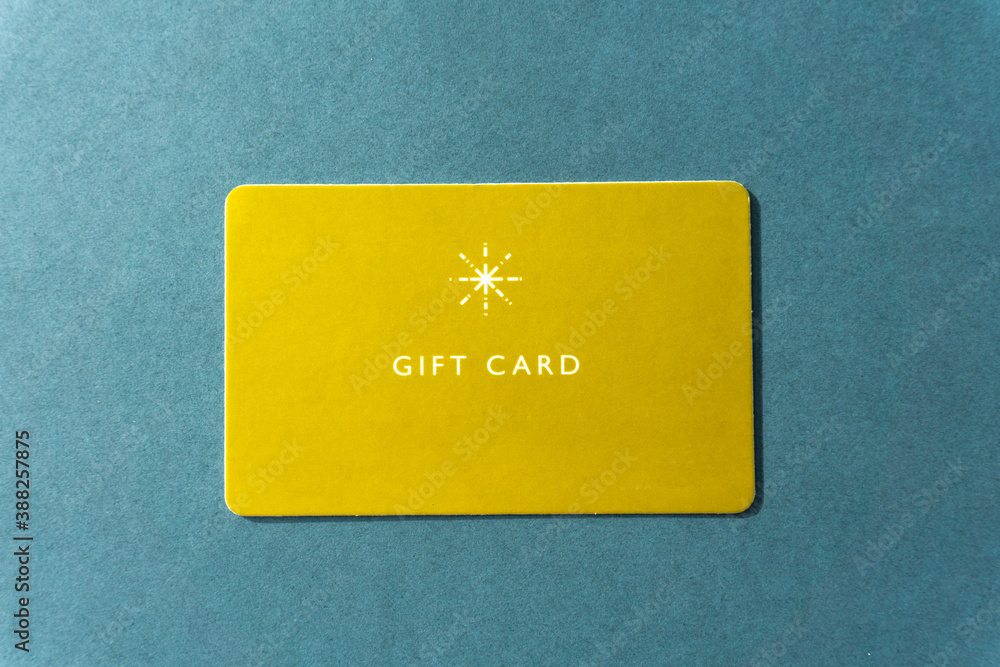 Gift card on green background. yellow gift card. Stock Photo | Adobe Stock