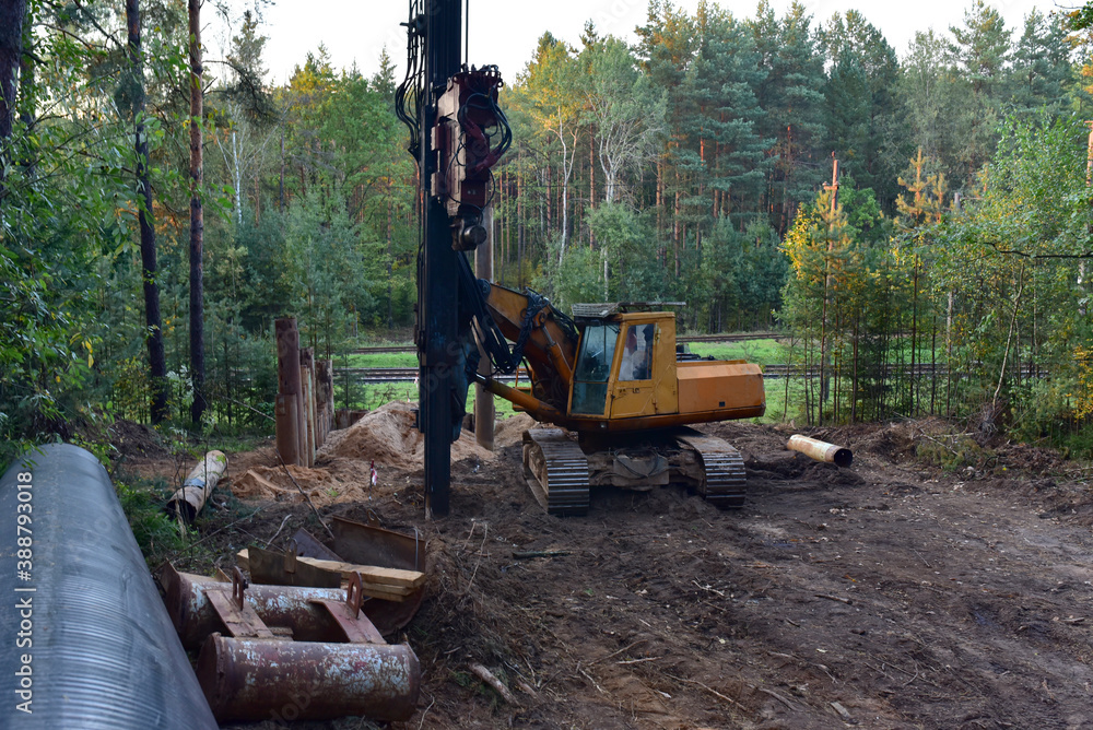 Vibrating hydraulic hammer in forest area. Hydraulically driven free ...