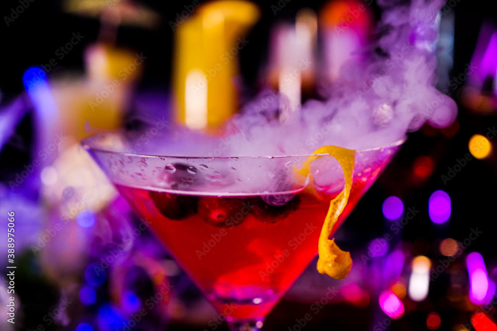 Cosmopolitan drink with cranberries at bar counter close up. Bartender ...