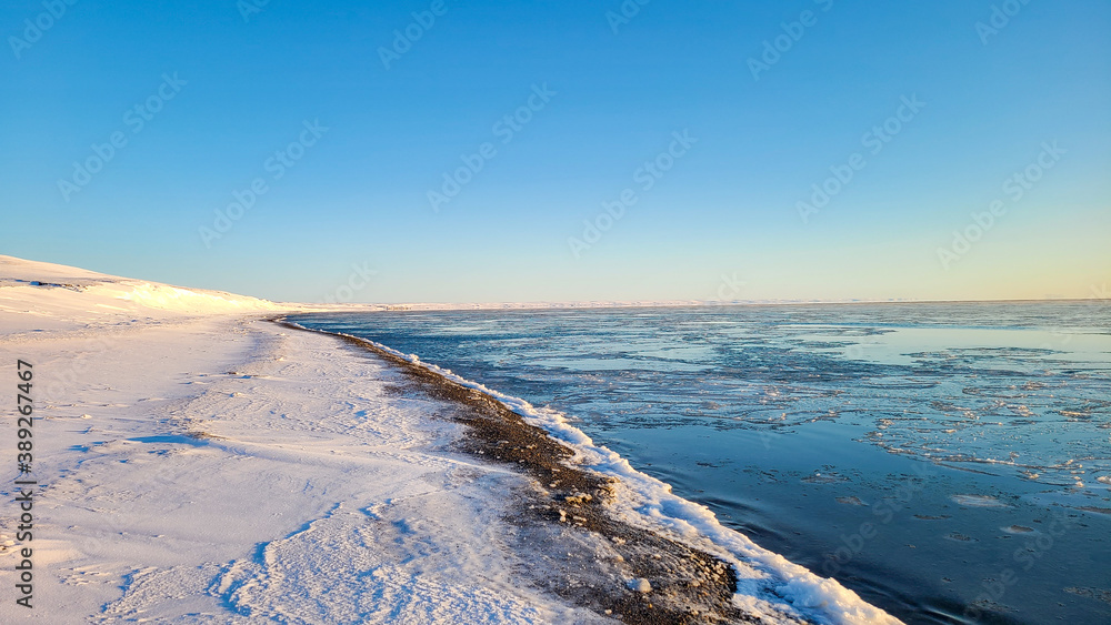 Arctic ocean starting to freeze at the shore line, near Sachs Harbour ...