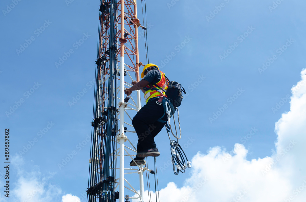 Engineer or Technician wear safety equipment climb high telecom tower ...