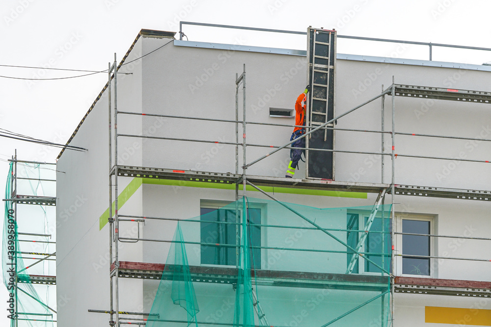 demolition of scaffolding after thermal insulation and painting of the ...
