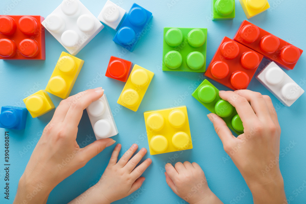 Young adult mother hands showing colorful plastic blocks to baby on ...