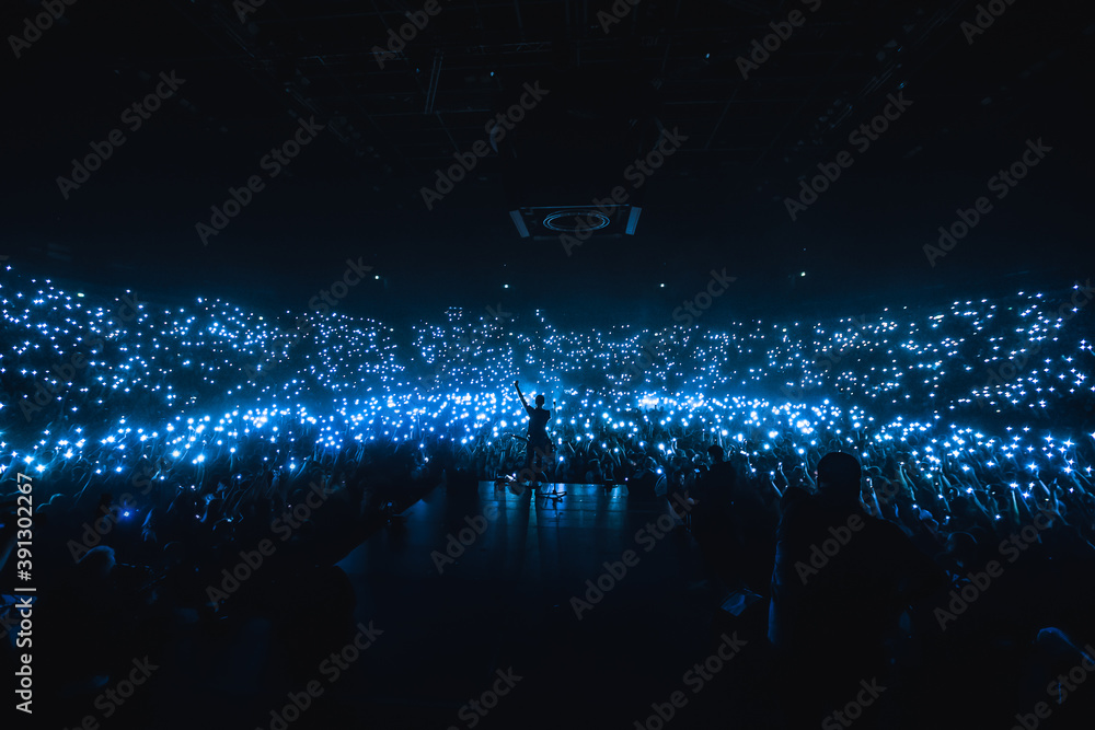 Foto Vocalist in front of crowd on scene in stadium. Bright stage ...