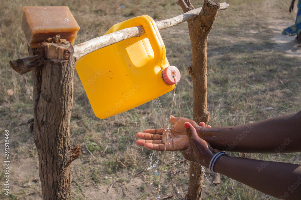 Pouring water from the innovation tool called tippy tap made of 5 liter ...