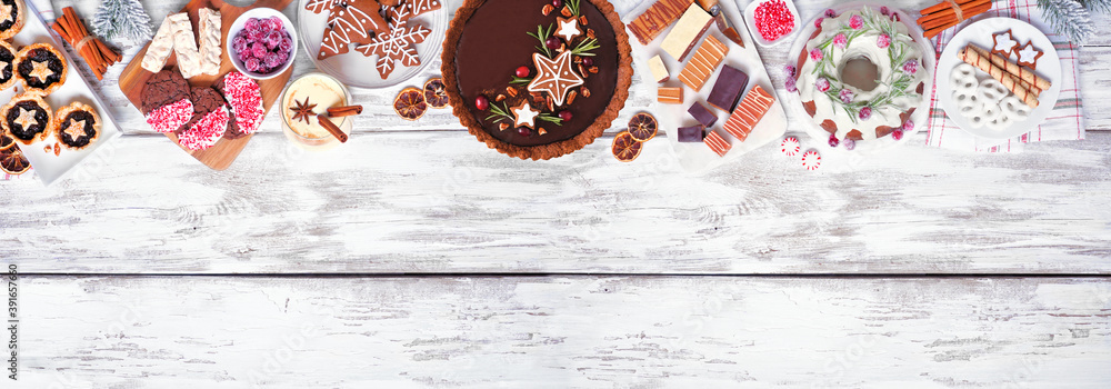 Variety of Christmas holiday desserts and sweets. Above view top border ...