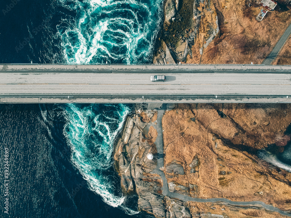 An aerial view on a hydrogen vehicle crossing a bridge with powerful ...