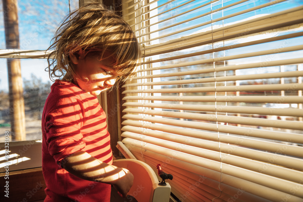 kid playing by the window Stock Photo | Adobe Stock