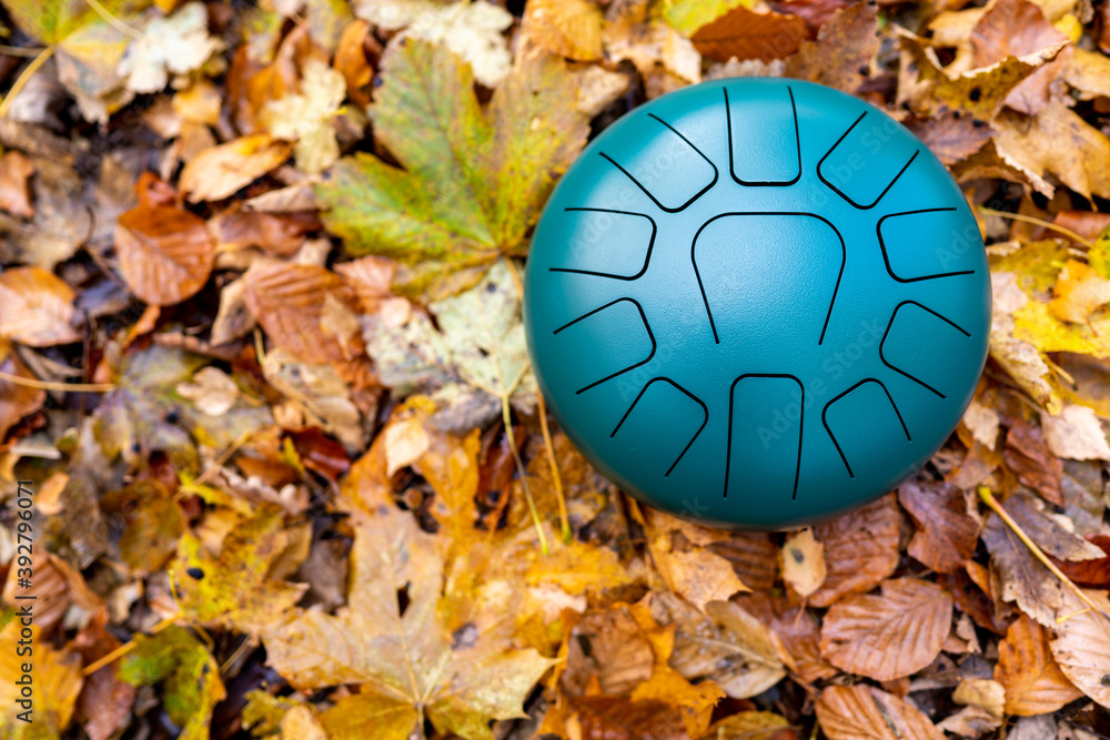 Hand pan tongue drum relaxing musical instrument placed on the right of ...