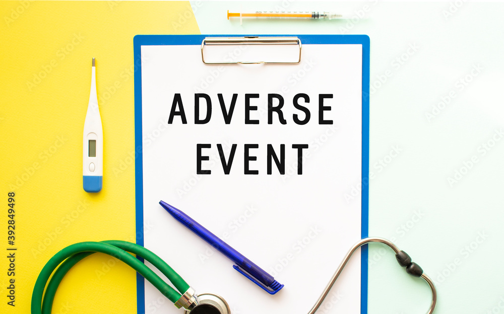 Text ADVERSE EVENT on a letterhead in a medical folder on a colorful ...
