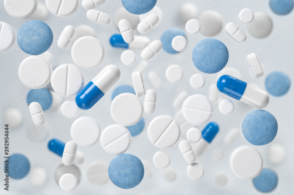 Floating white and blue pills and capsules Stock Photo | Adobe Stock