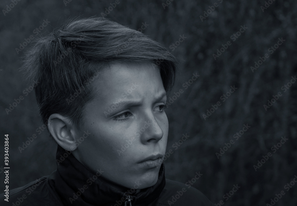 Dramatic black and white close-up portrait of a 13-year-old boy. A ...