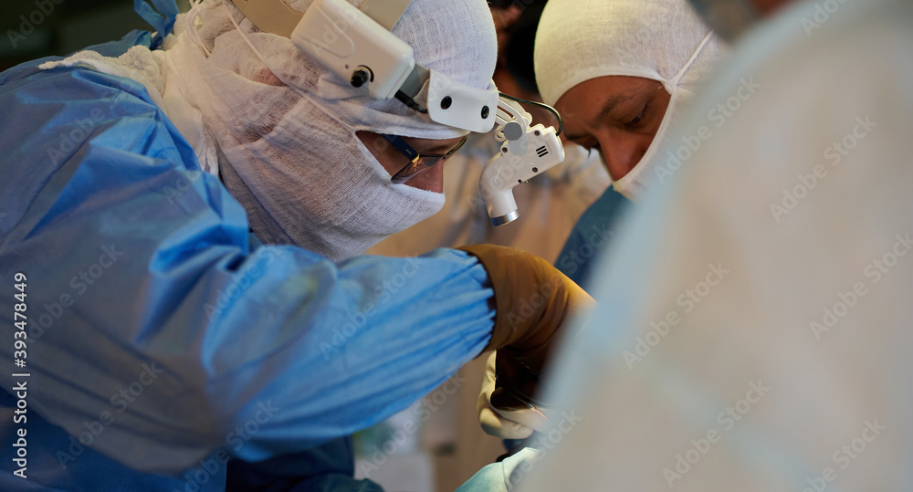 Surgical operation, view from behind the shoulder of the operating ...