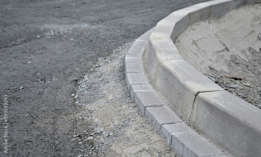 installation of concrete curb into concrete. in the space of the road ...