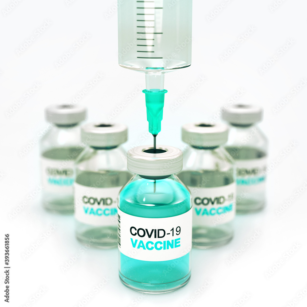 Small bottles of Covid-19 vaccine and medical injection above on bright ...